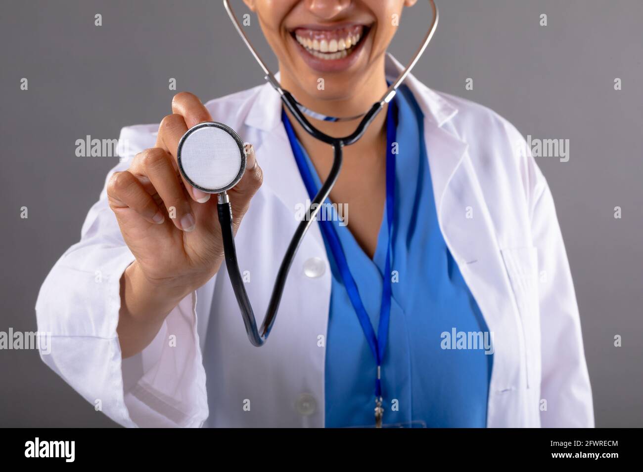 Mid section of african american female doctor holding stethoscope ...