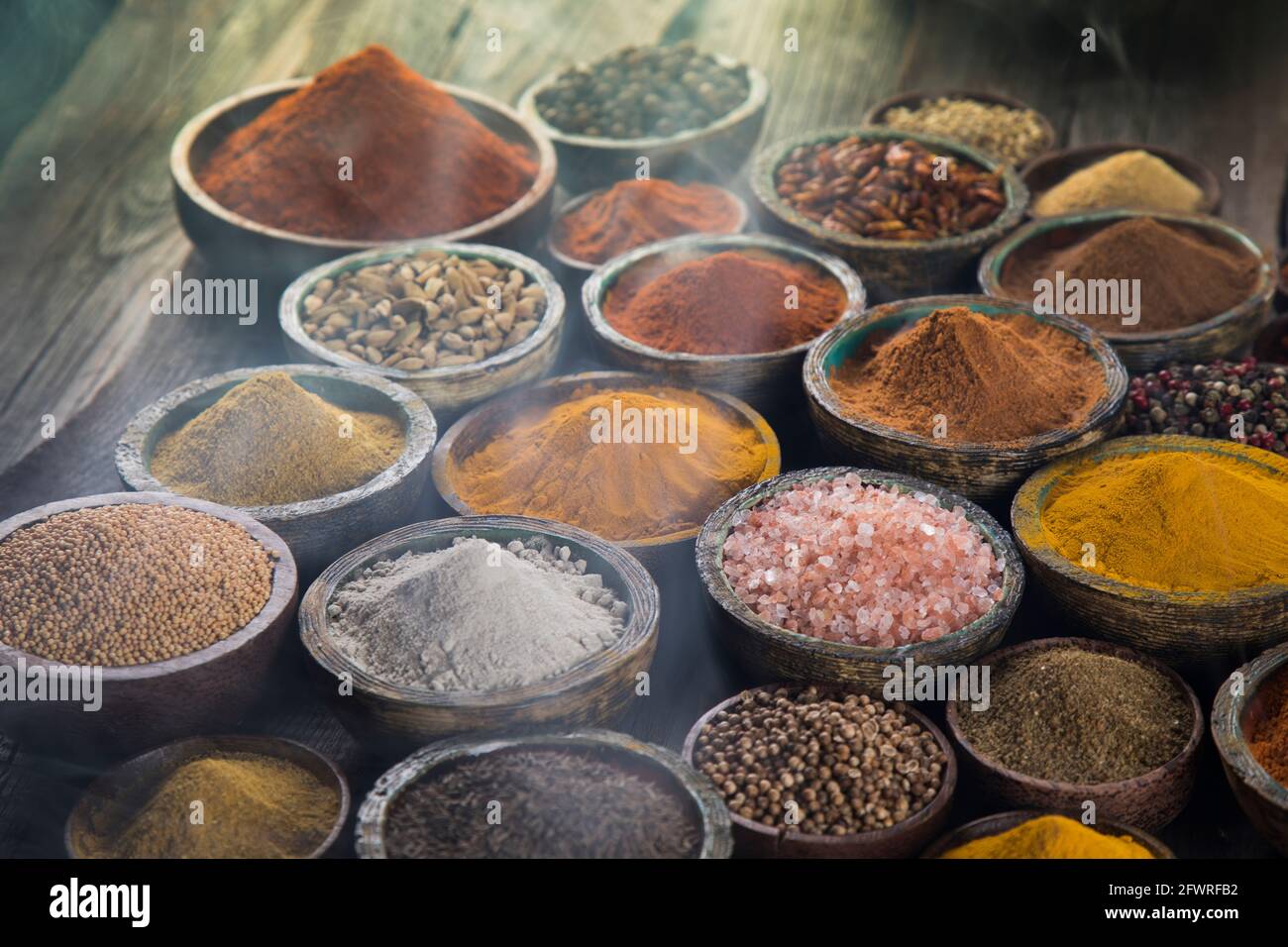 Smoke, Aromatic spices on wooden background Stock Photo - Alamy