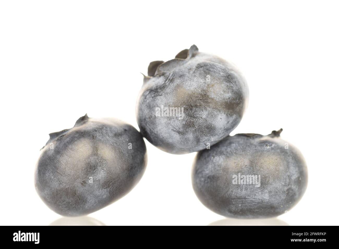 Three ripe dark purple blueberries, close-up, isolated on white Stock ...