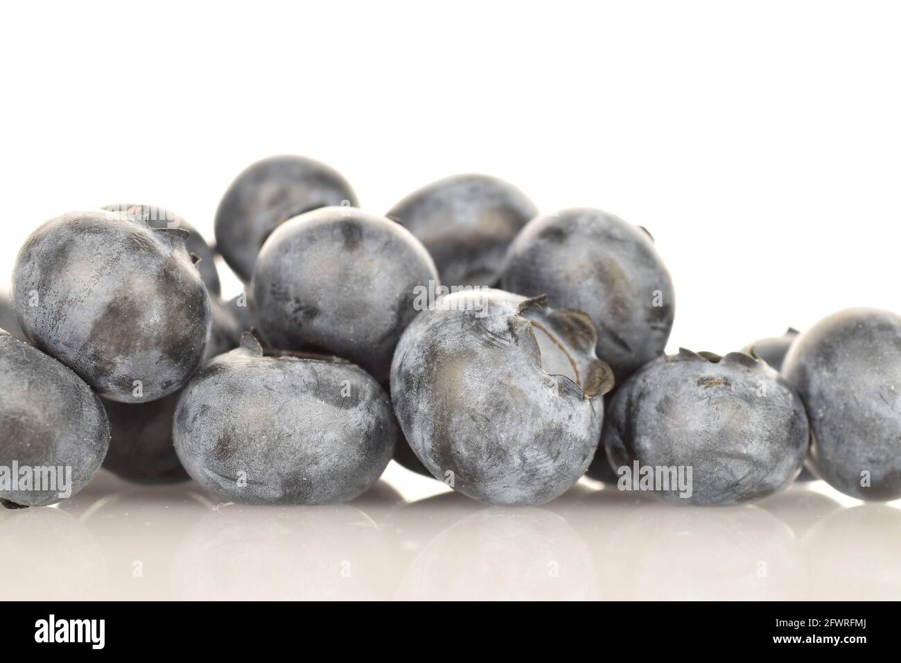 A lot of ripe dark purple blueberries, close-up, isolated on white ...