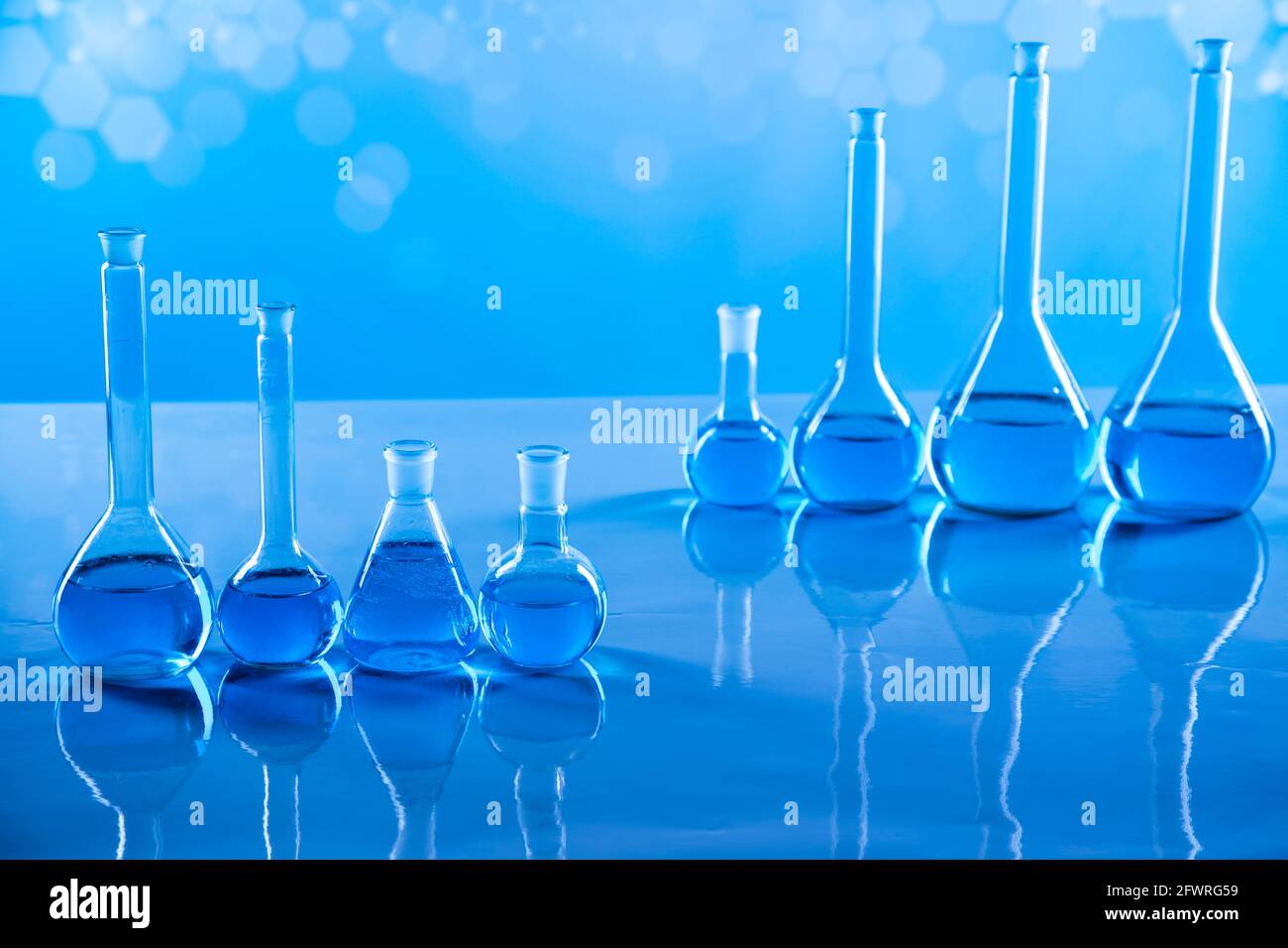 Laboratory beakers,Science experiment, blue background Stock Photo - Alamy