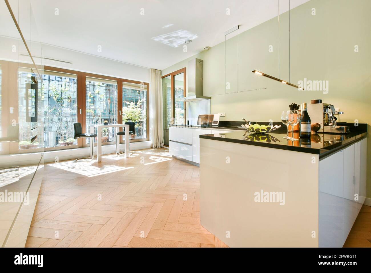 Big panoramic windows in light kitchen with white cabinets and black ...
