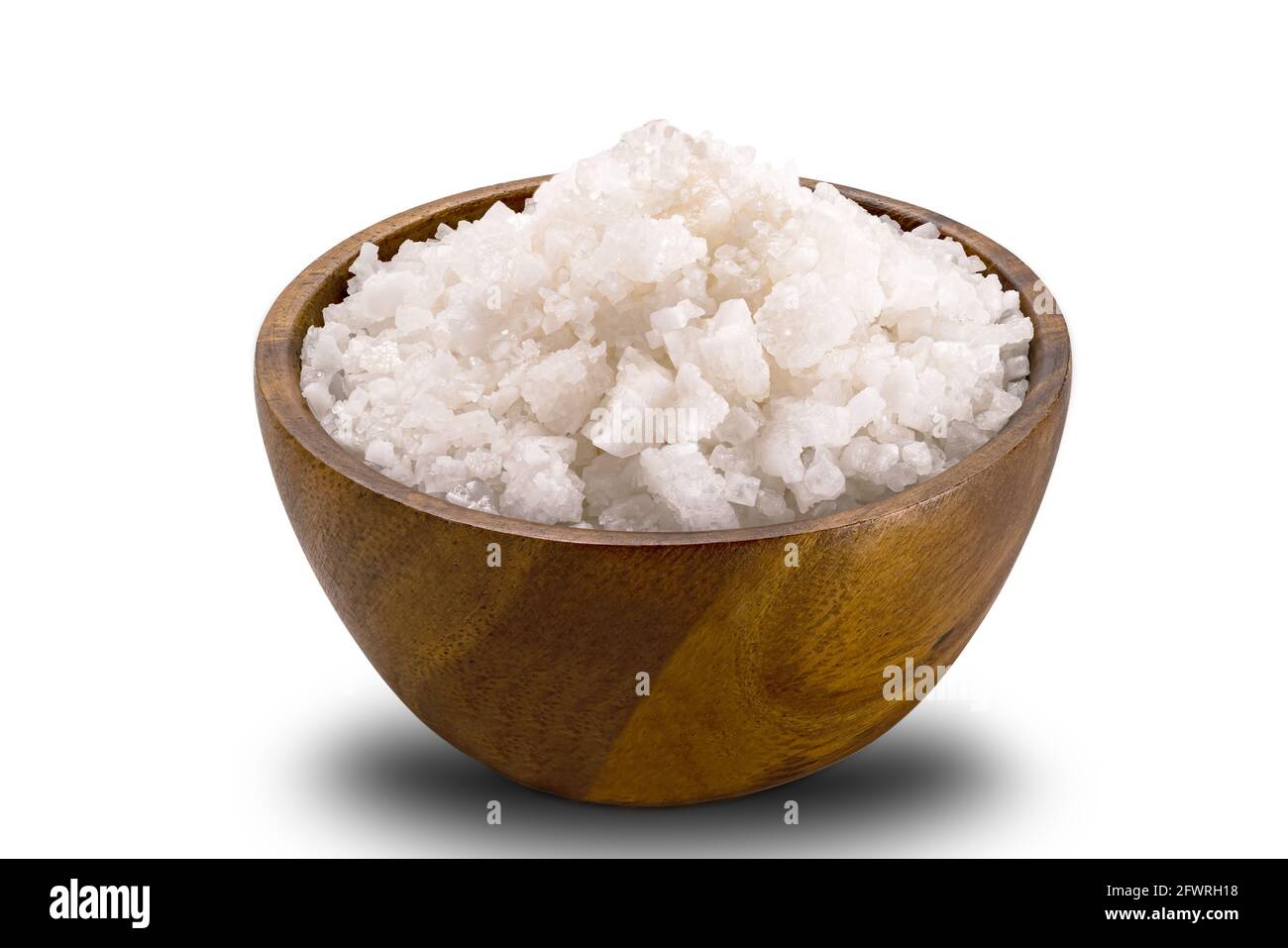 Side view of natural sea salt in wooden bowl on white background with ...