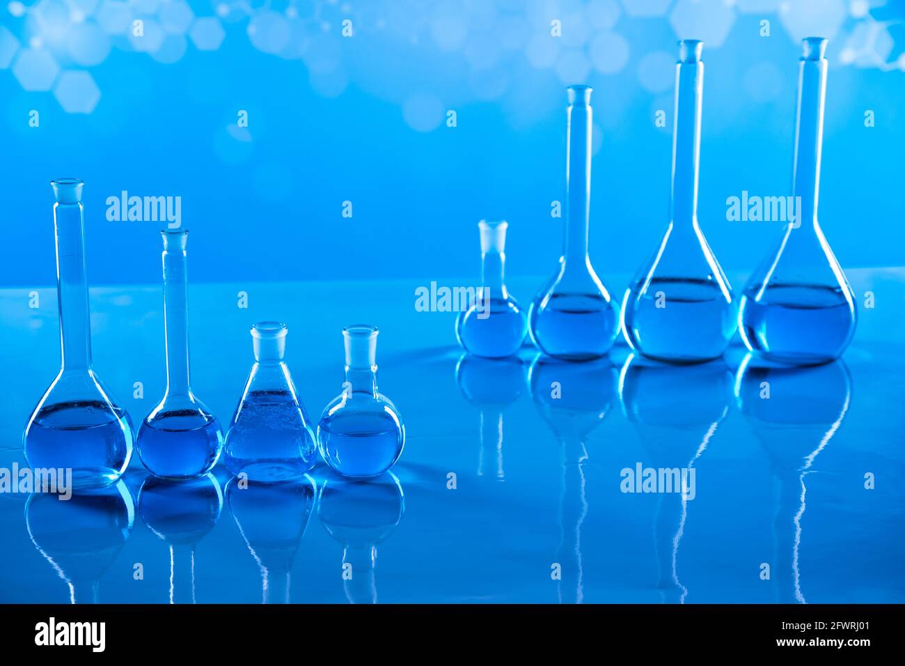 Laboratory beakers,Science experiment, blue background Stock Photo - Alamy
