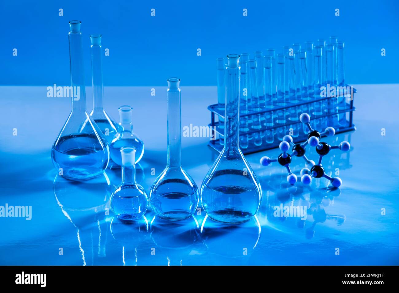 Laboratory beakers,Science experiment, blue background Stock Photo - Alamy