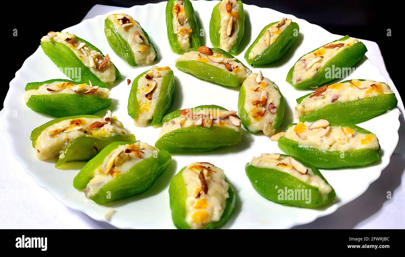 Pointed gourd sweets isolated in black background. Diwali special gourd ...