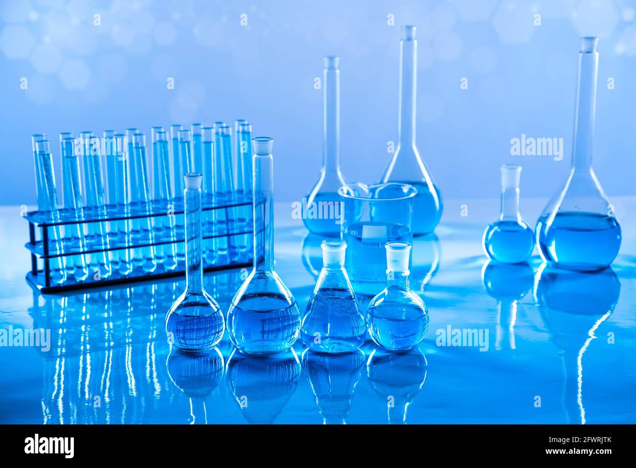 Laboratory beakers,Science experiment, blue background Stock Photo - Alamy