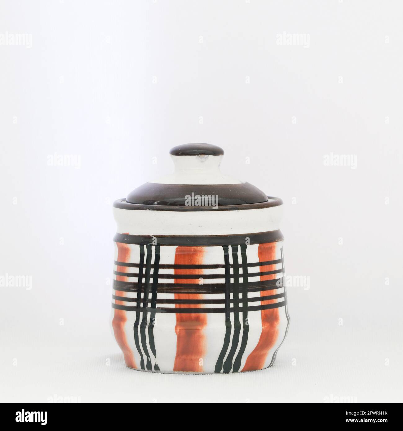 traditional antique jar used to store food isolated in a white ...