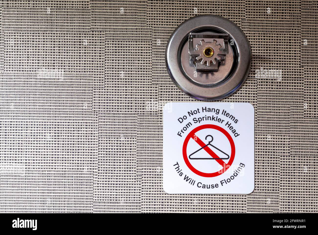 Do not hang items on sprinkler head, this will cause flooding sign ...