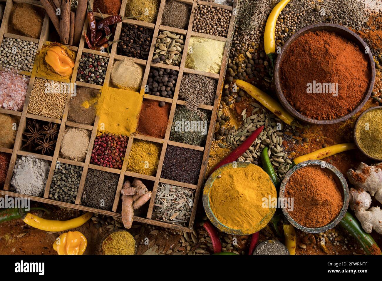 Wooden table of colorful spices Stock Photo - Alamy