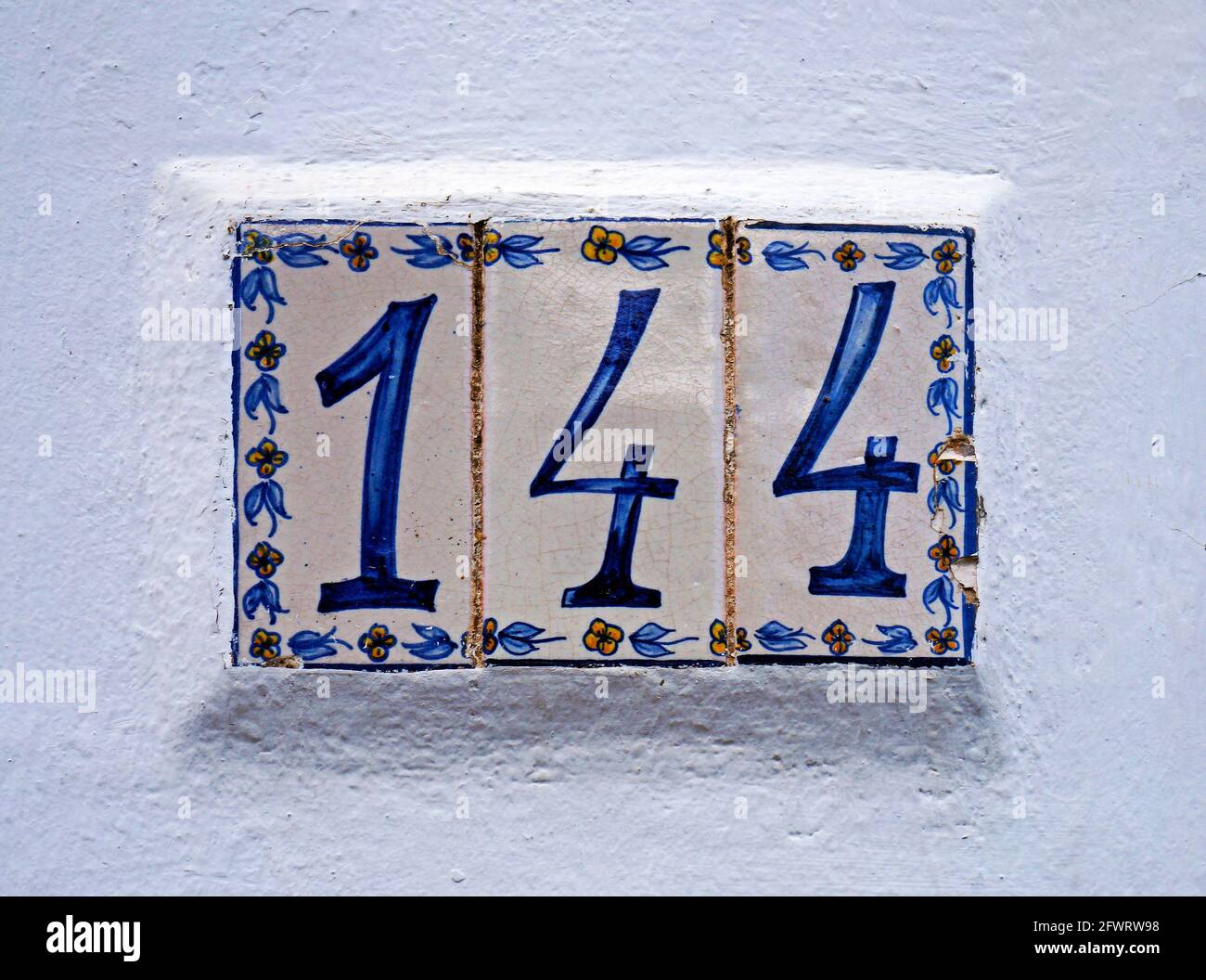 Street sign number 144 on a white wall Stock Photo - Alamy