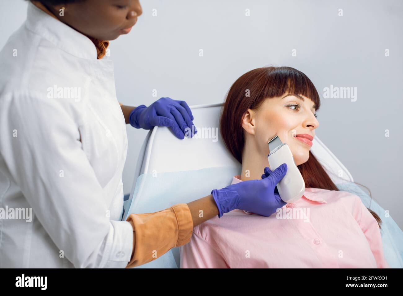 Cleansing facial skin, remove blackheads in dermatology clinic. Young ...