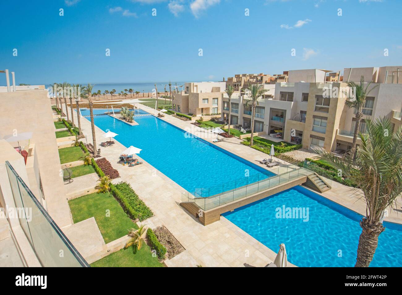 Aerial view of large swimming pool with garden at a luxury tropical ...