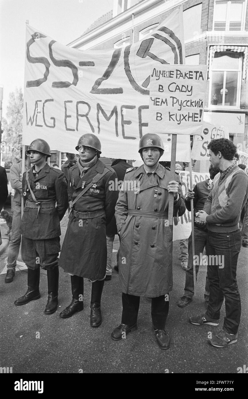 Demonstrators dressed as Russian soldiers holding sign against SS-20 ...