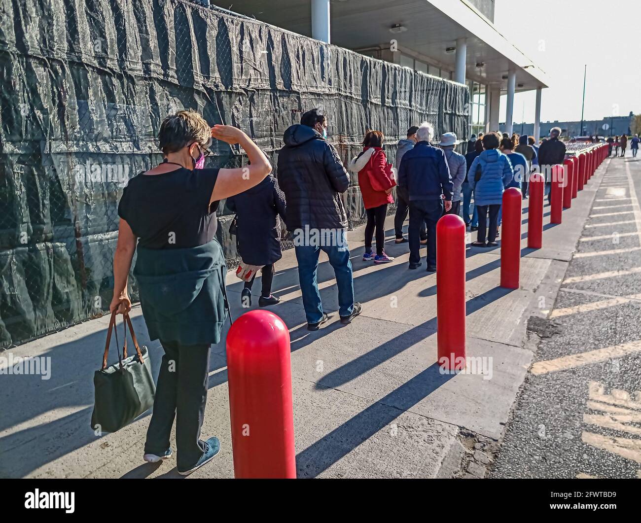 Toronto, Ontario, Canada, May 2021 - Customers line up in the early ...