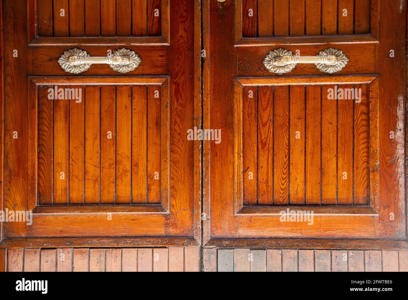 Old wooden door with shiny metal handle in the. Door handle closeup ...