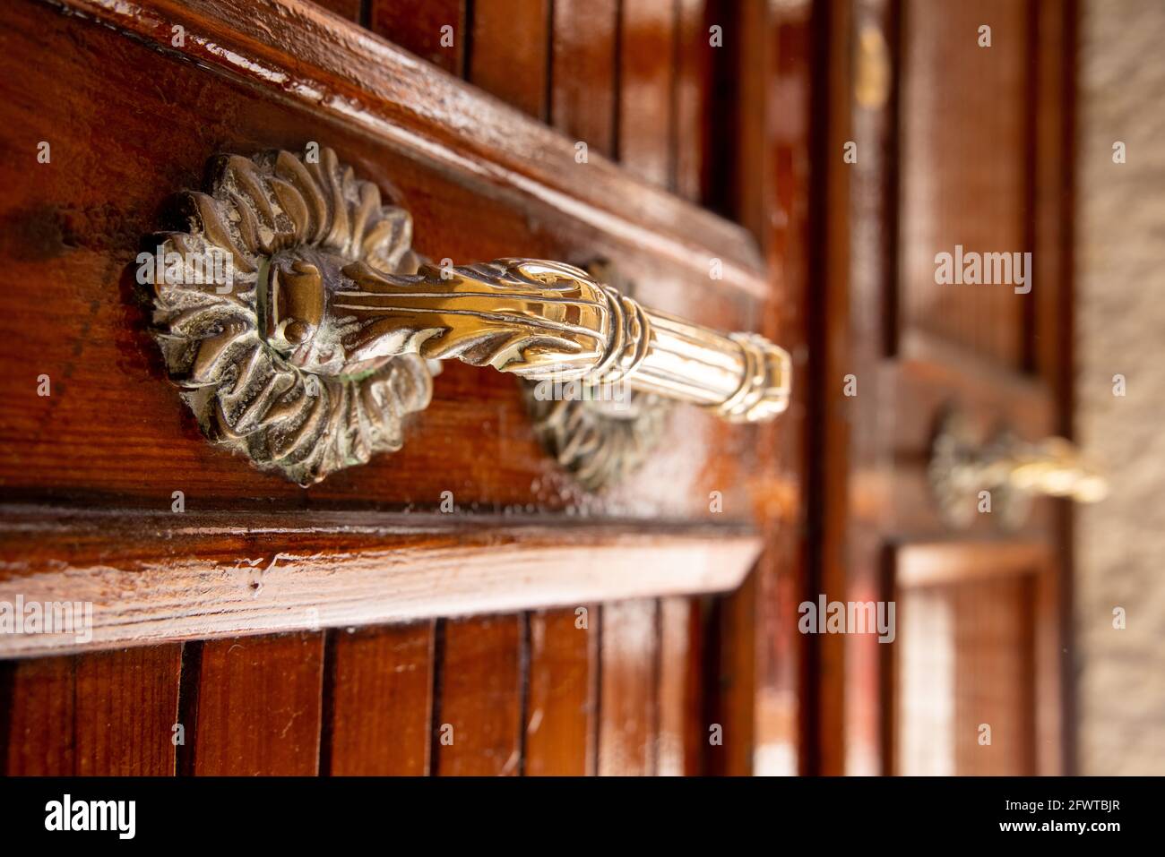 Old wooden door with shiny metal handle in the. Door handle closeup ...