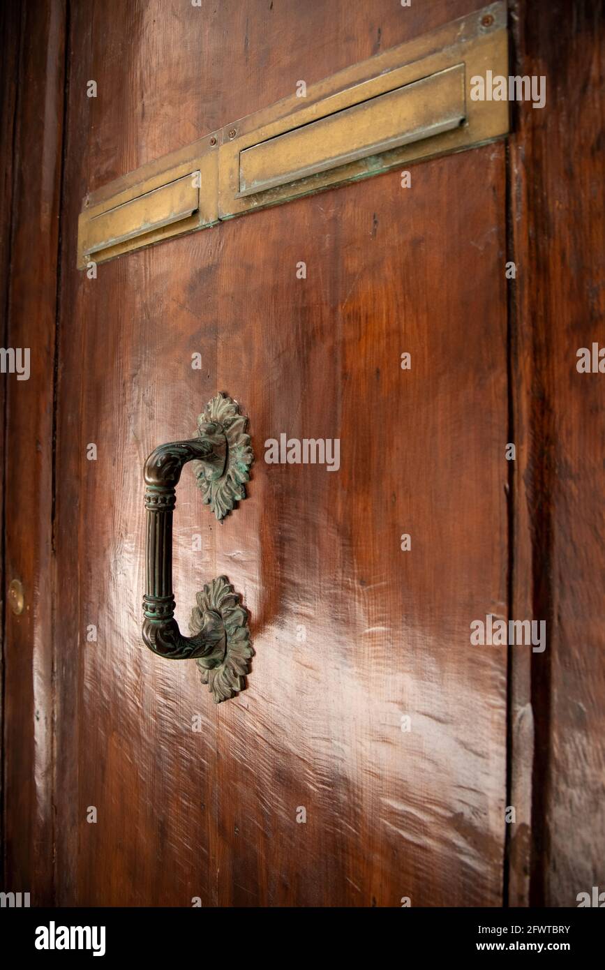 Old wooden door with shiny metal handle in the. Door handle closeup ...