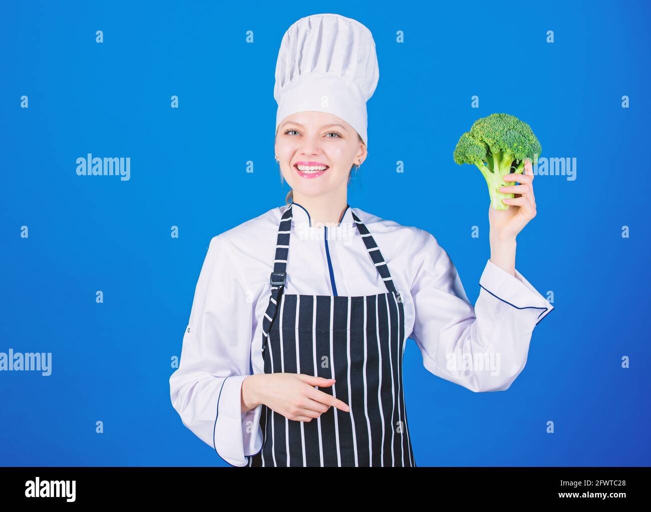 Including healthy organic foods in your life. Happy woman chef holding ...