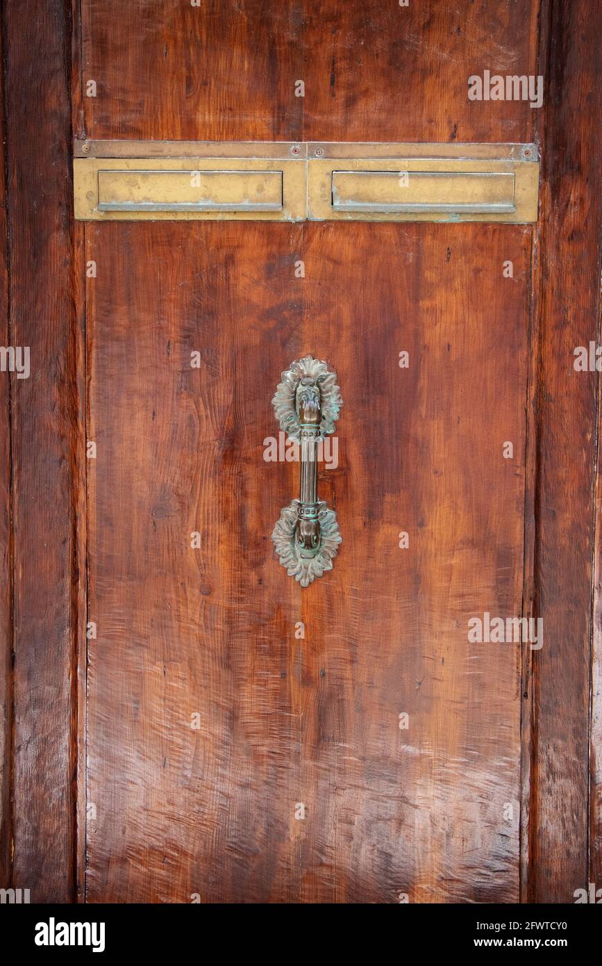 Old wooden door with shiny metal handle in the. Door handle closeup ...