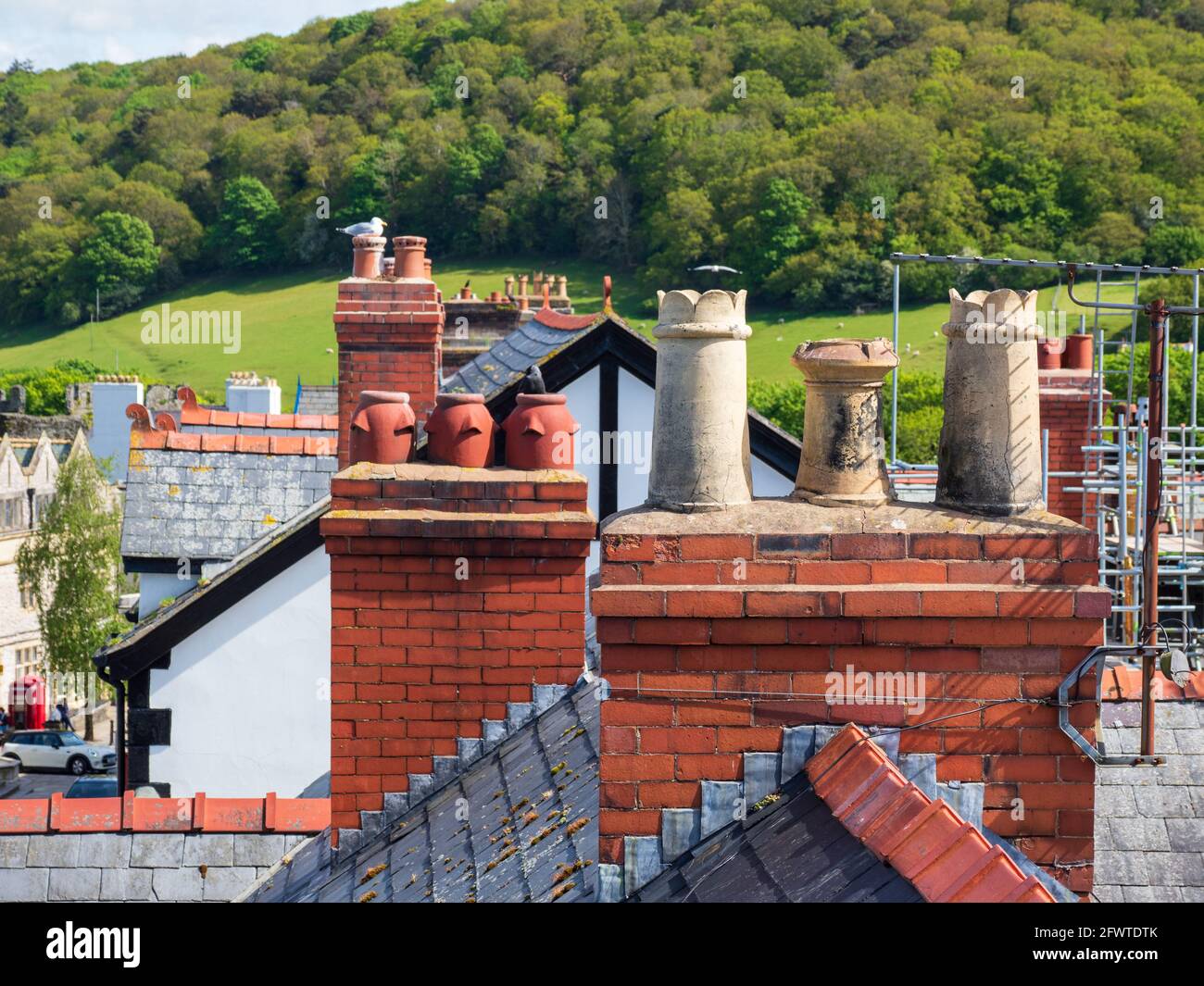 chimney pots and stacks on slated roofed houses Great Britain Stock ...