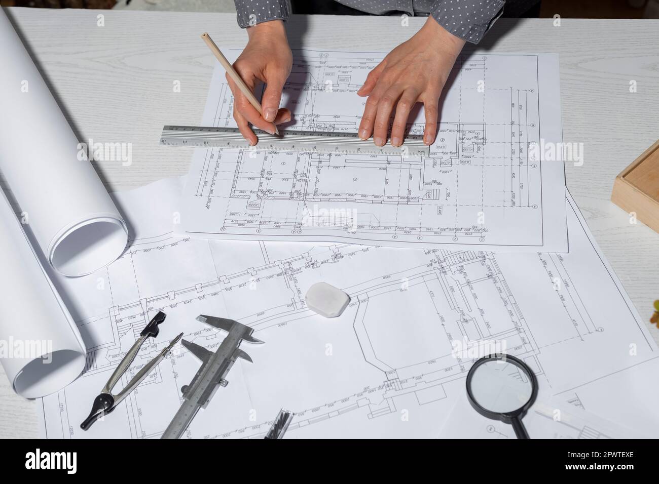 Architect designer draws a sketch of the project on white paper ...