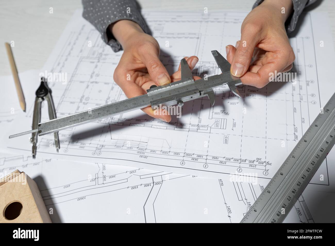 Architect designer draws a sketch of the project on white paper ...