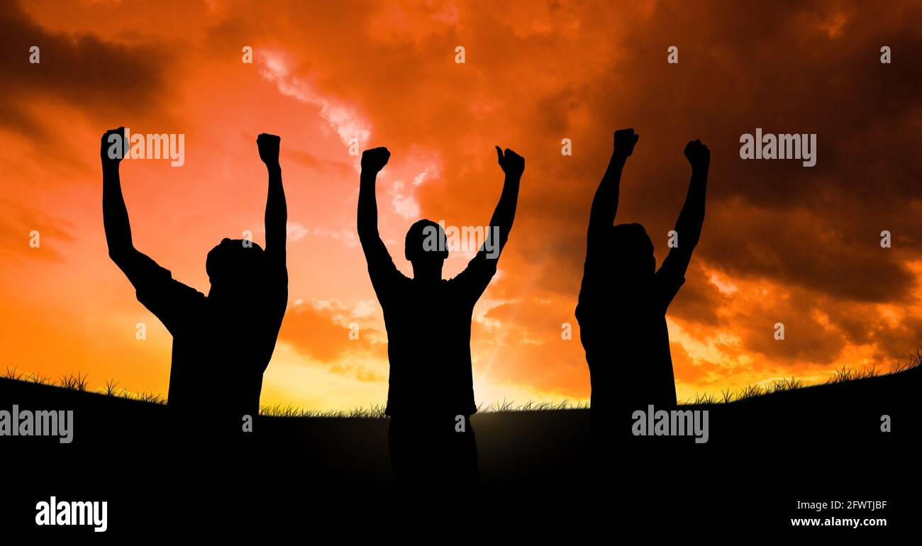 Composition of group of silhouettes raising hands over sunset Stock ...