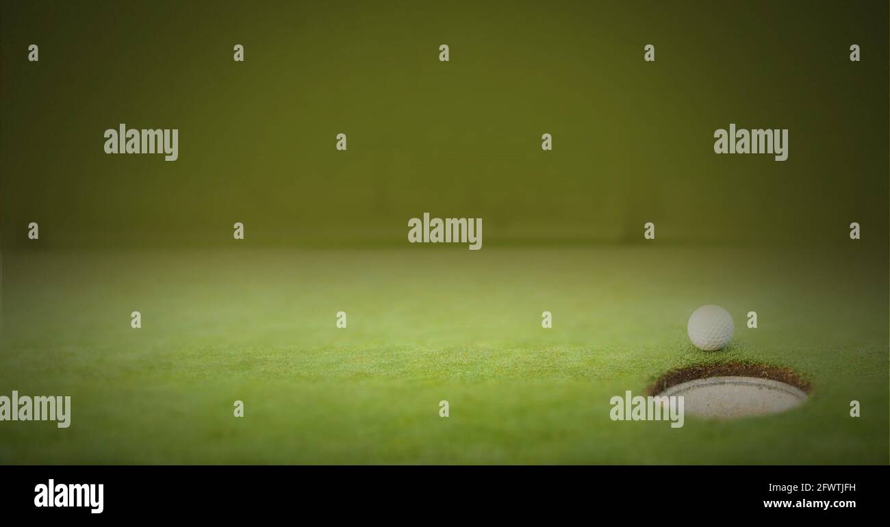 Composition of golf ball on golf course over green blur Stock Photo - Alamy