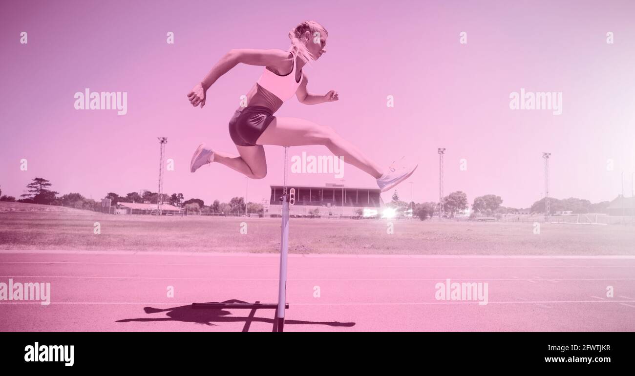 Composition of fit caucasian female athlete hurdle jumping with copy ...