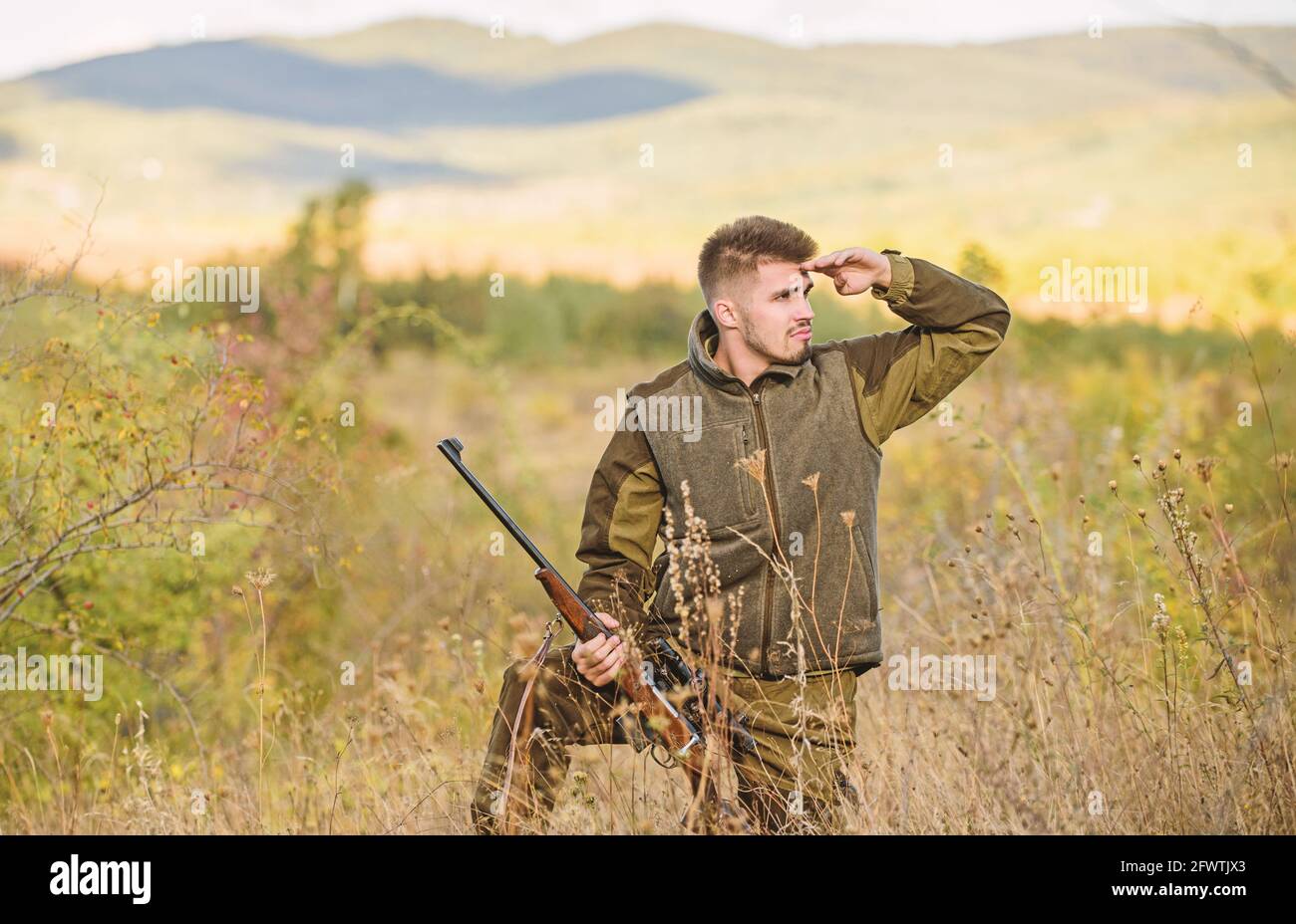 Hunter hold rifle. Focus and concentration of experienced hunter ...