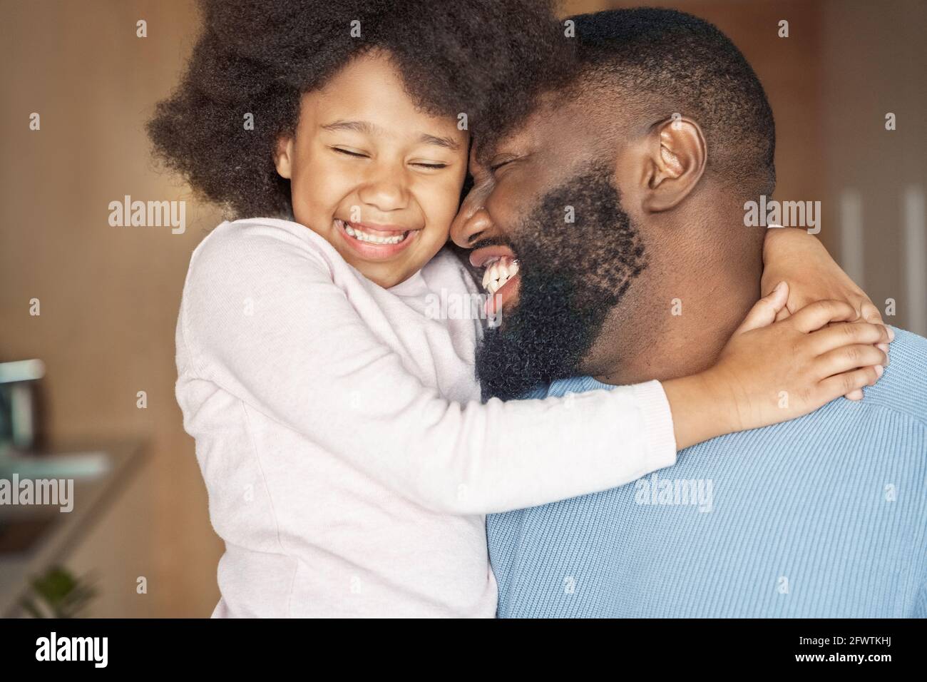 Happy laughing african american father and daughter indoors headshot ... Happy laughing african american father and daughter indoors headshot ...