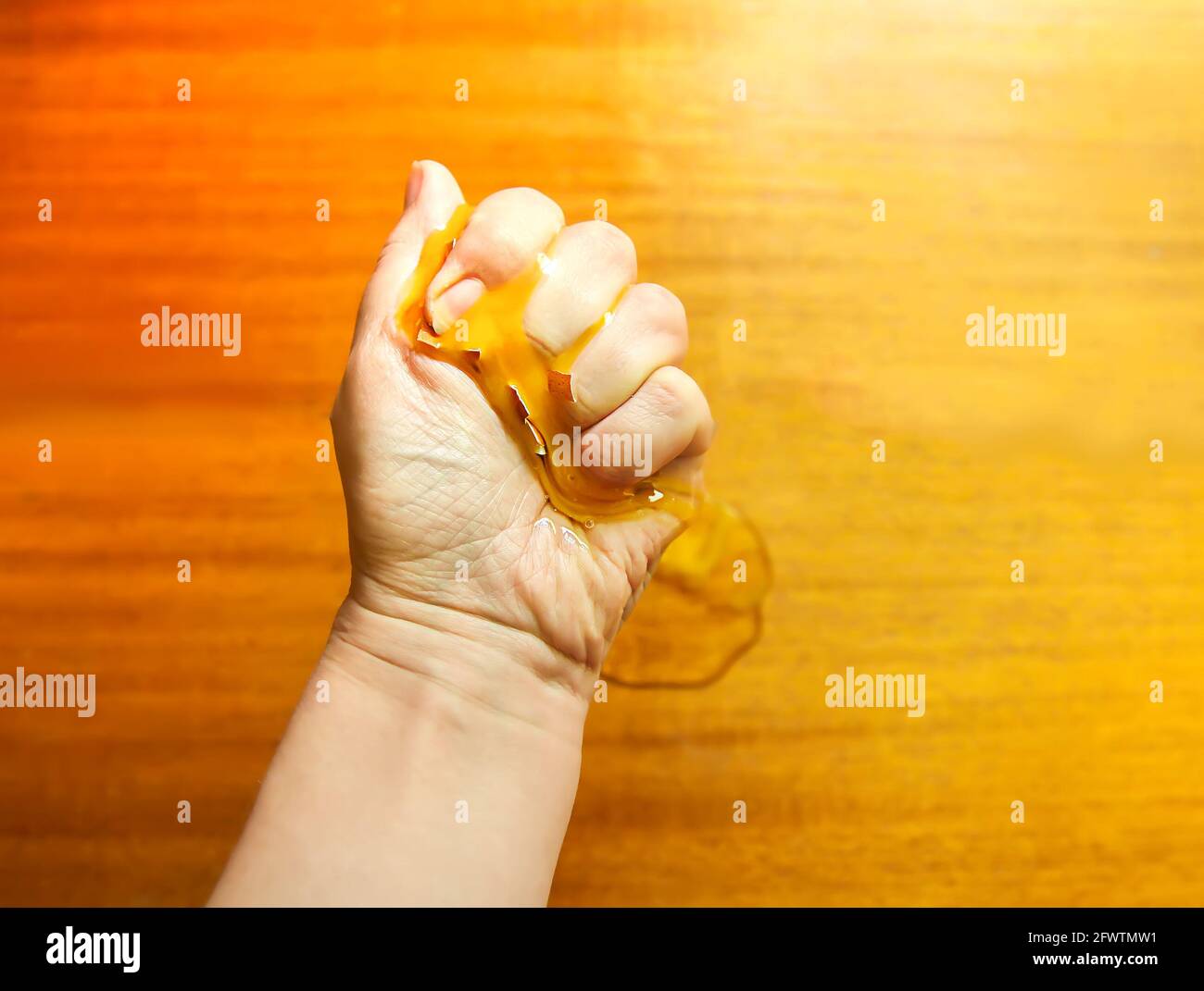 Raw smashed egg in a hand Stock Photo - Alamy