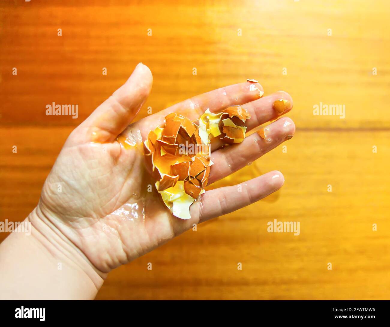 Raw smashed egg in a hand Stock Photo - Alamy