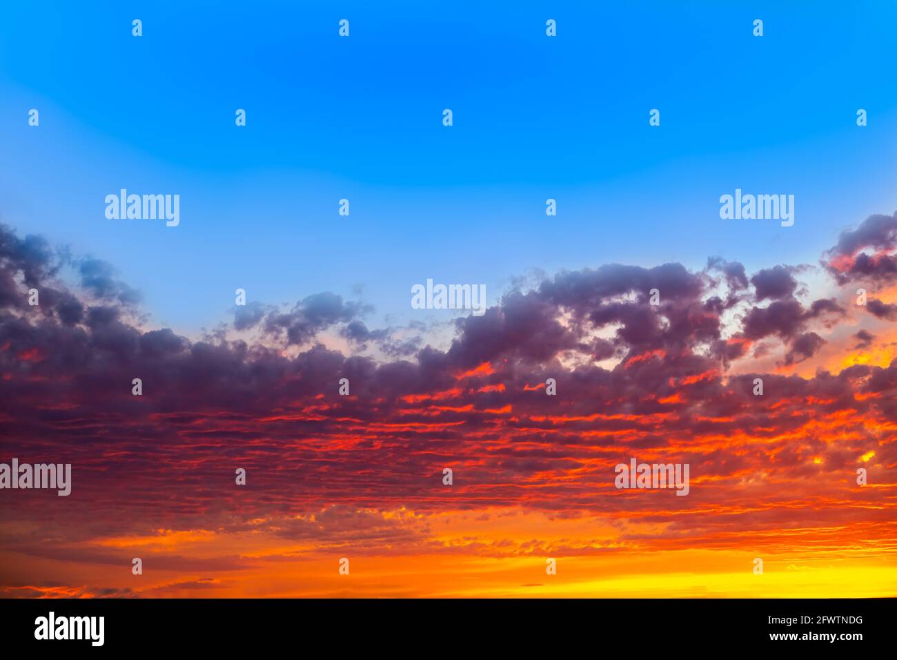 Bright contrasting dramatic sky with clouds at sunset. Saturated colors ...