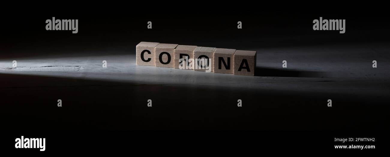 wooden blocks building the word corona, black background Stock Photo ...