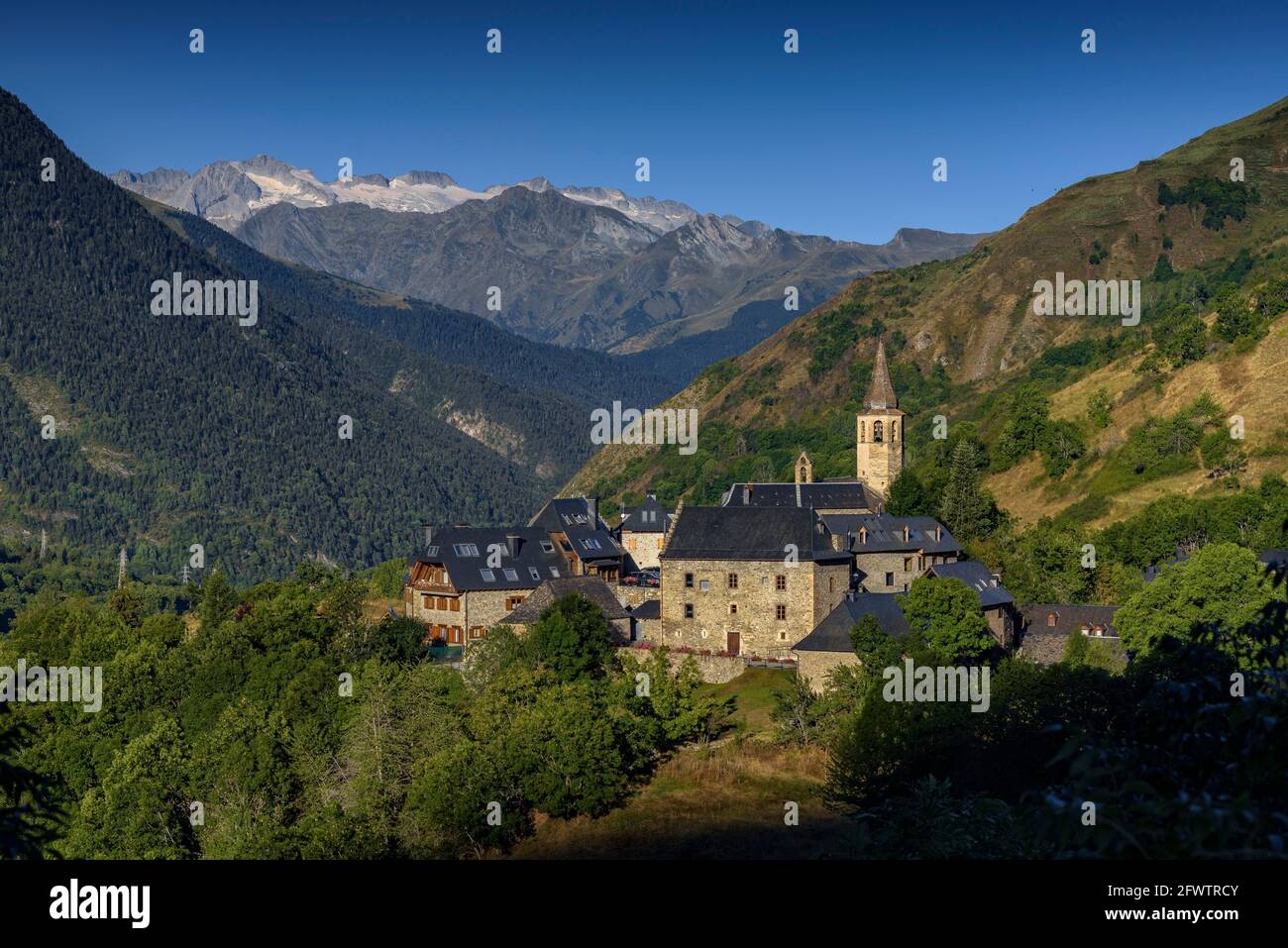 Unha village, in a summer morning. In the background, the massif of the ...