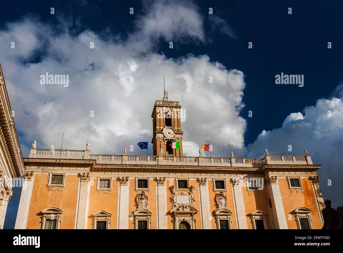 Rome City Hall with old clock tower among clouds at the top of ...