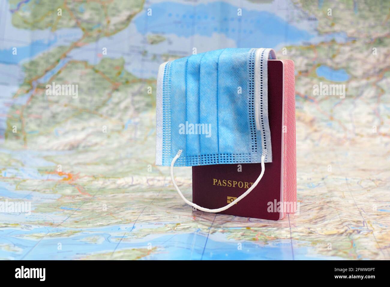 medical face mask on passport on map Stock Photo - Alamy