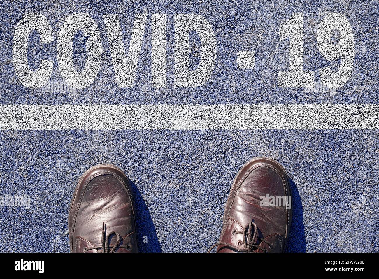 top view of man feet standing before border line on asphalt and text ...
