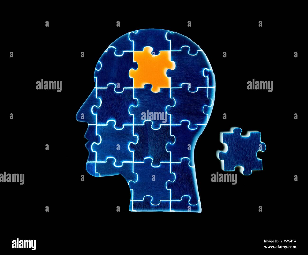 Blue human head shaped jigsaw puzzle with the final piece to be set in ...