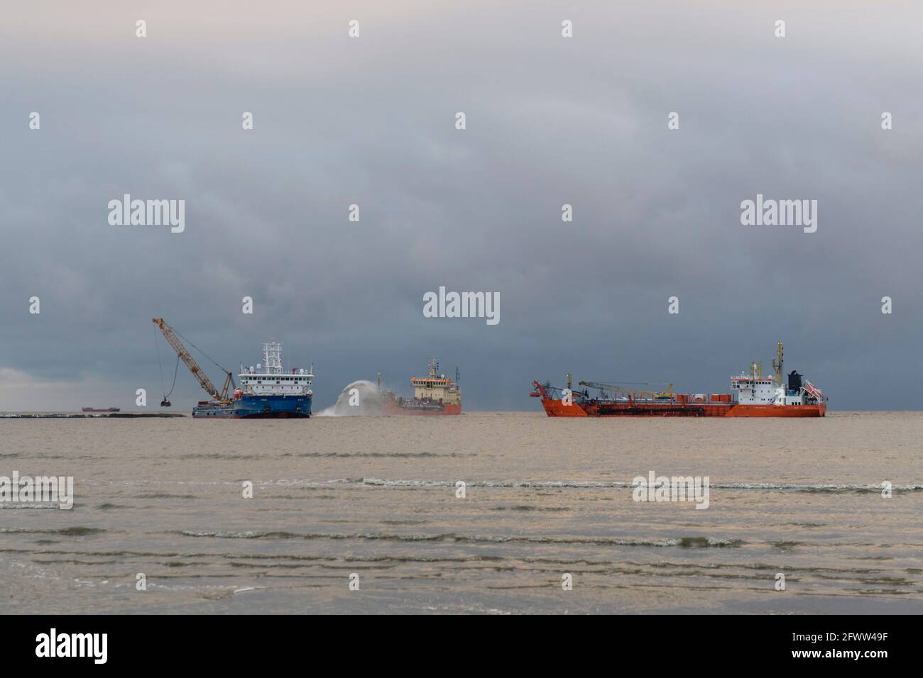 Vessel engaged in dredging. Dredger working at sea. Ship excavating ...