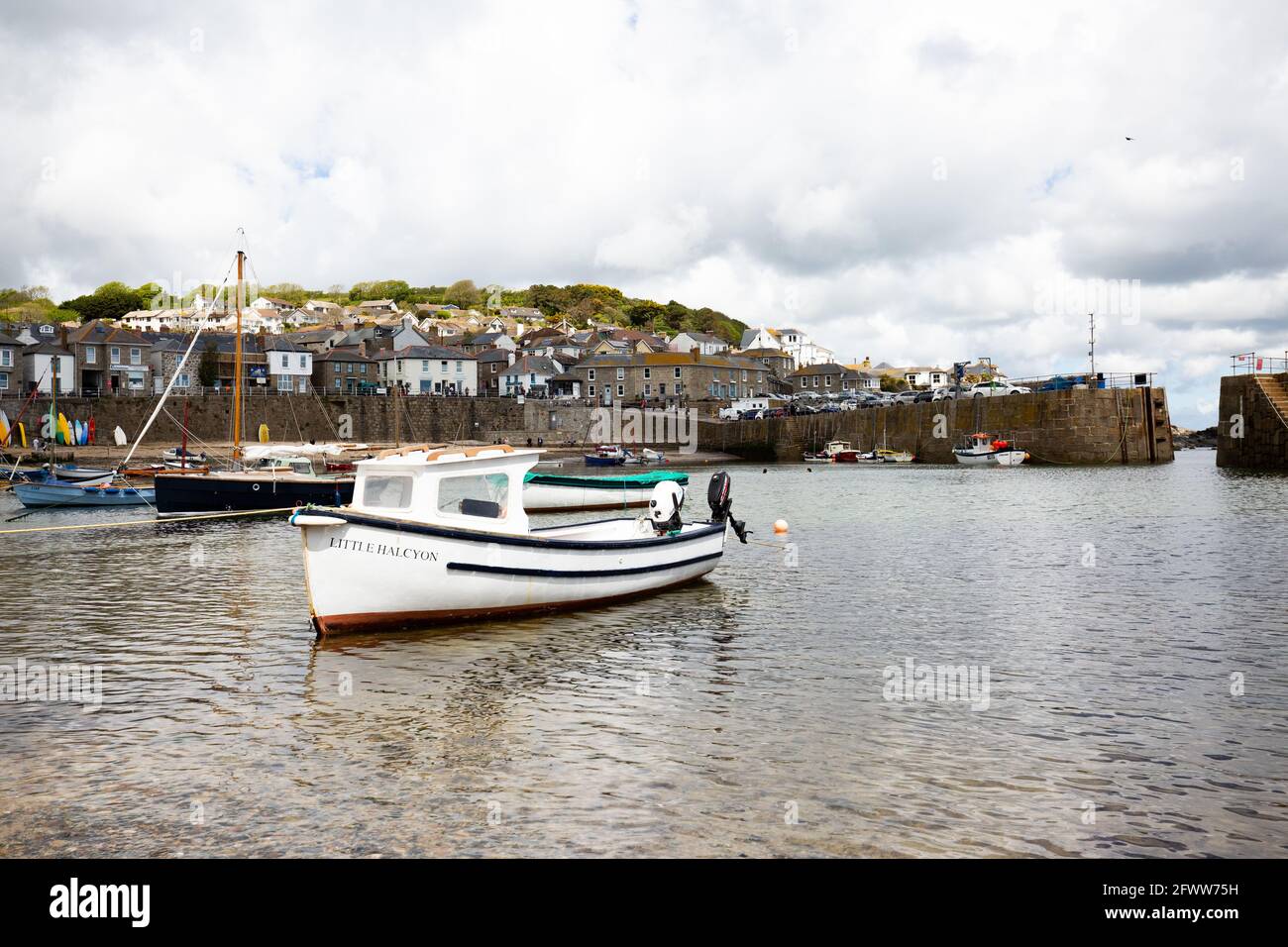 Small boats in the harbour at low tide in Mousehole, Cornwall Stock ...