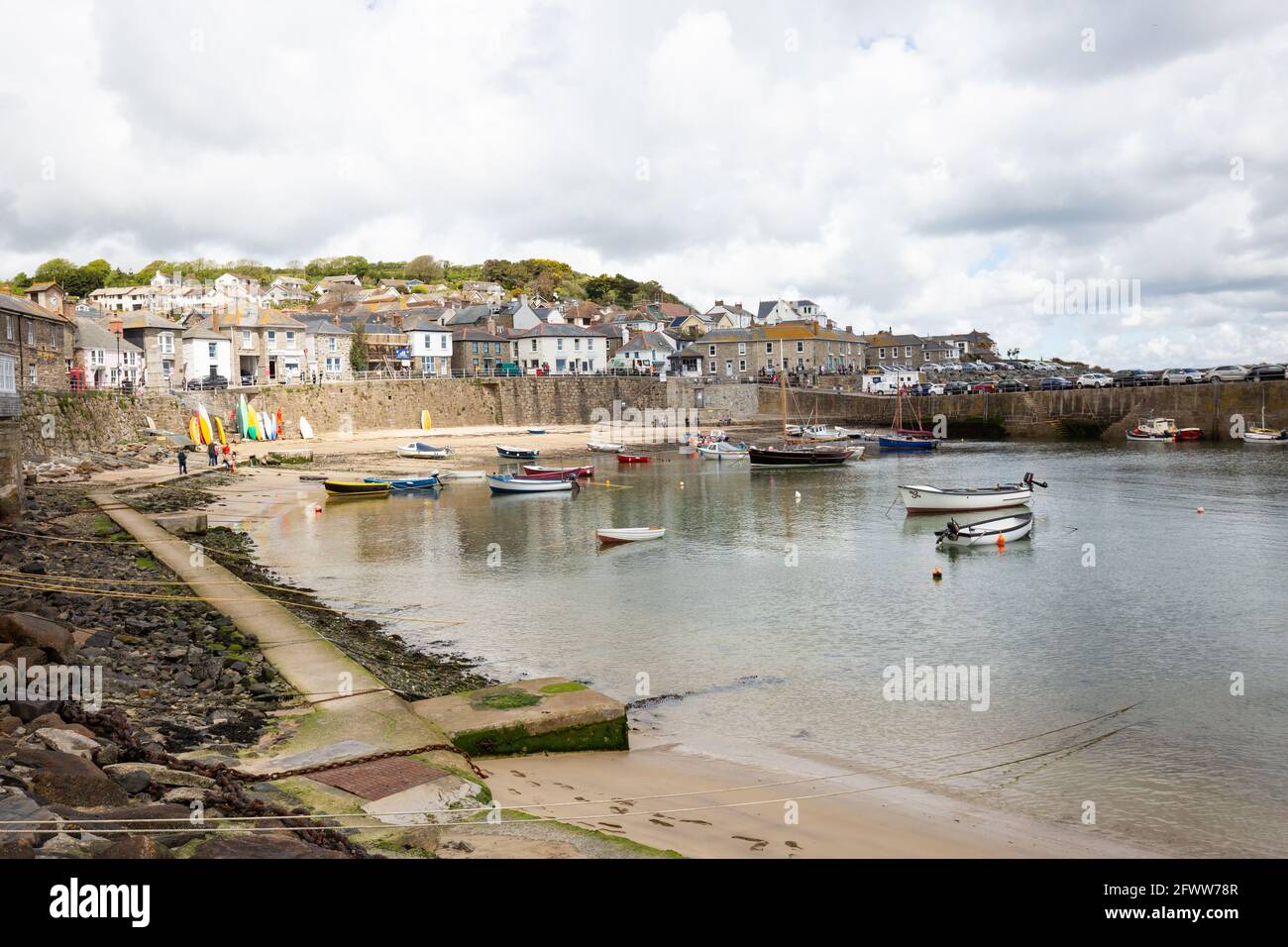 Small boats in the harbour at low tide in Mousehole, Cornwall Stock ...