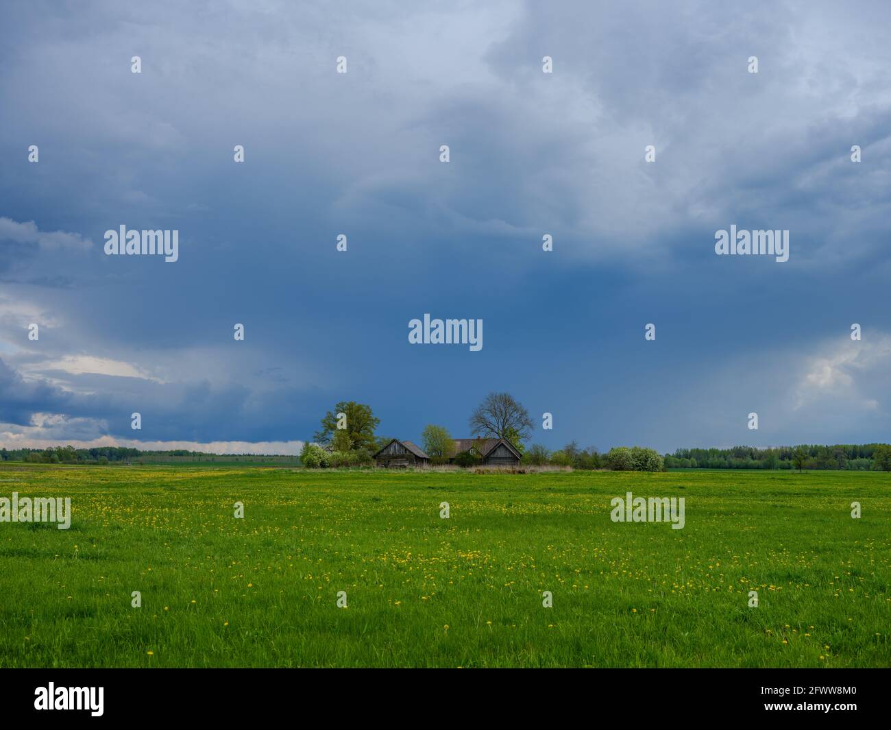 broken summer clouds over countryside fields and meadows in summer with ...