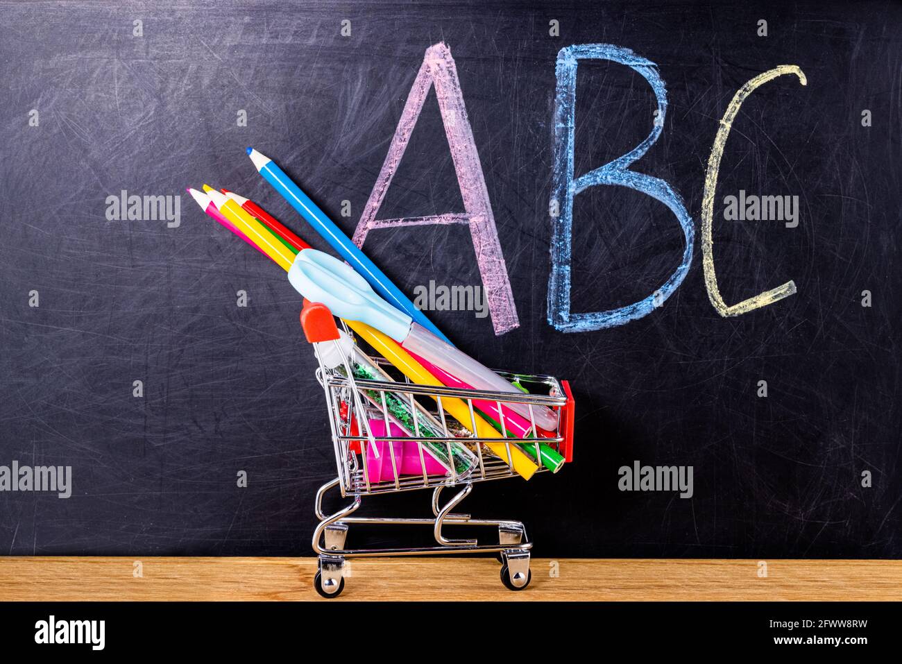 Shopping cart with school pencils and stationery against the background ...