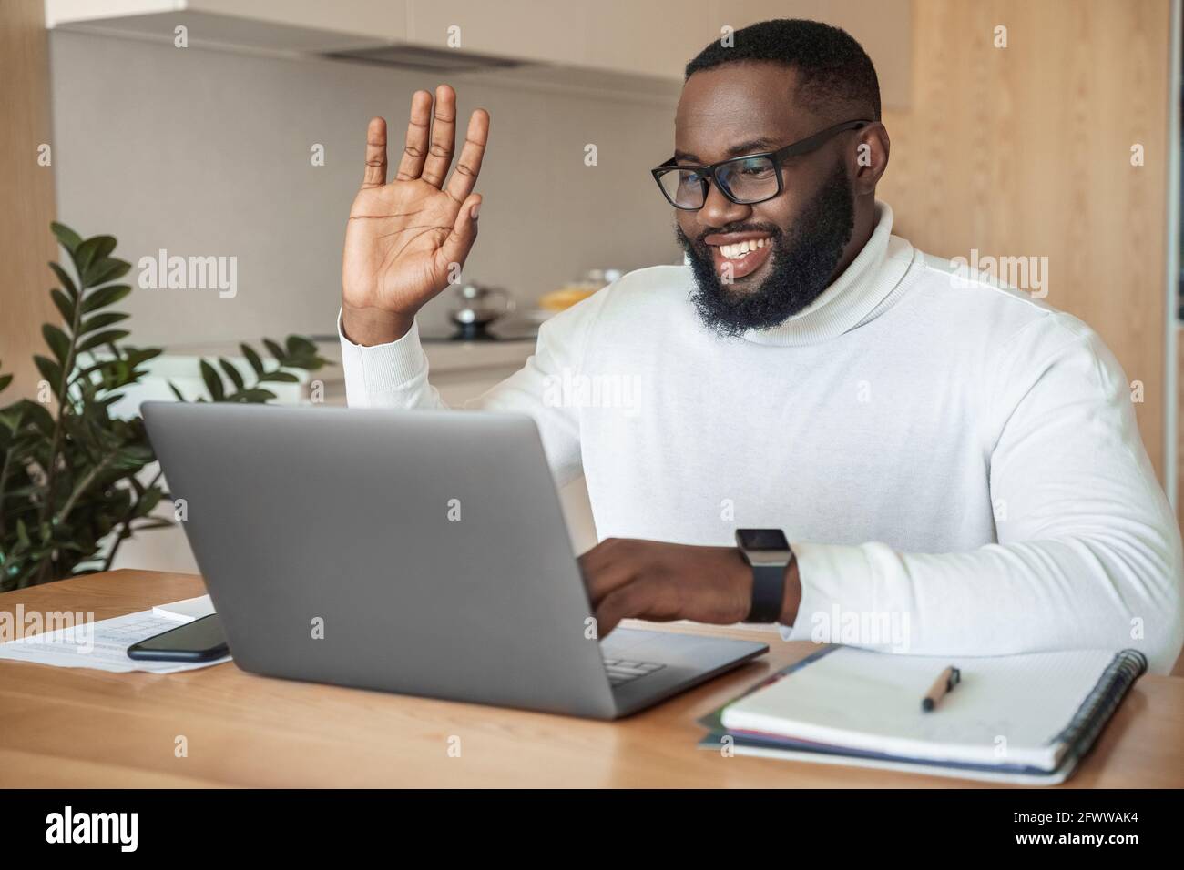 Portrait of friendly smiling bearded black man greeting online ...