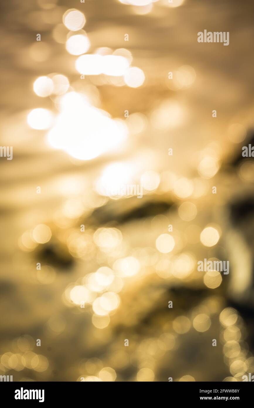 Bokeh shapes and shadows on water surfaces on the coast creating ...