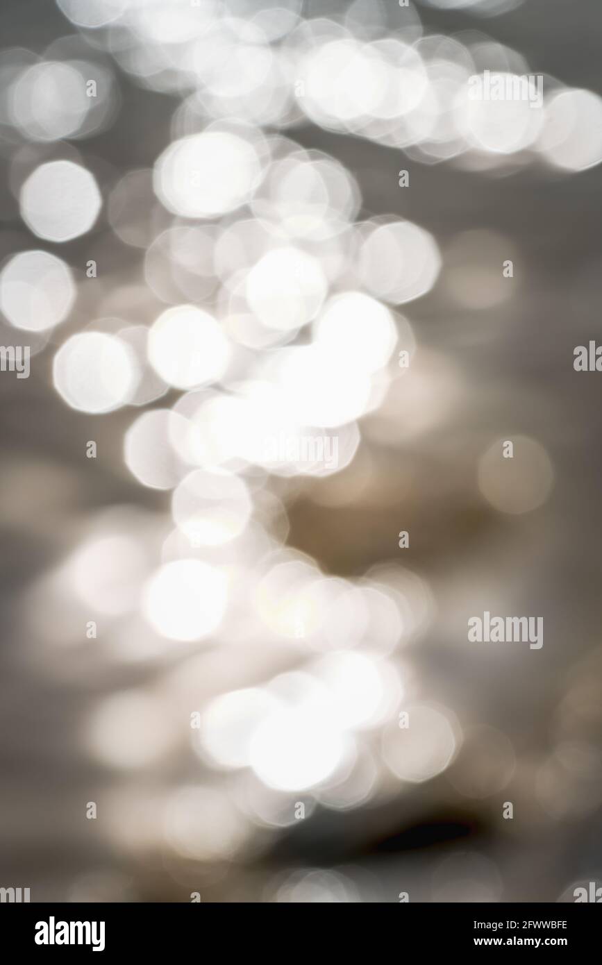 Bokeh shapes and shadows on water surfaces on the coast creating ...