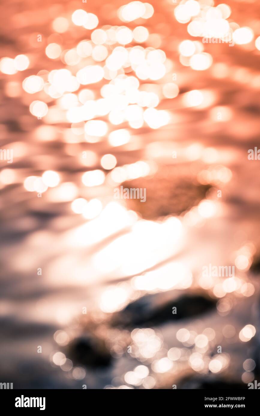 Bokeh shapes and shadows on water surfaces on the coast creating ...